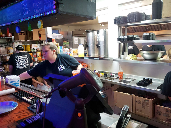 Behind every great burger is a dedicated crew. The kitchen staff moves with the practiced choreography of burger ballet masters.