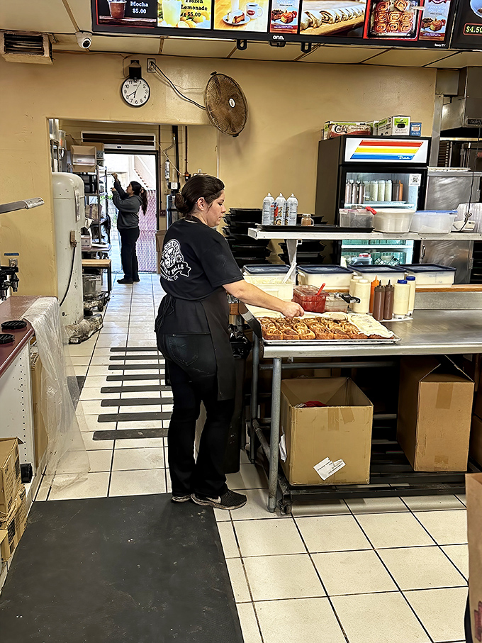 Craftsmanship in action. The staff works with the focused precision of artists, each cinnamon roll a masterpiece in the making.