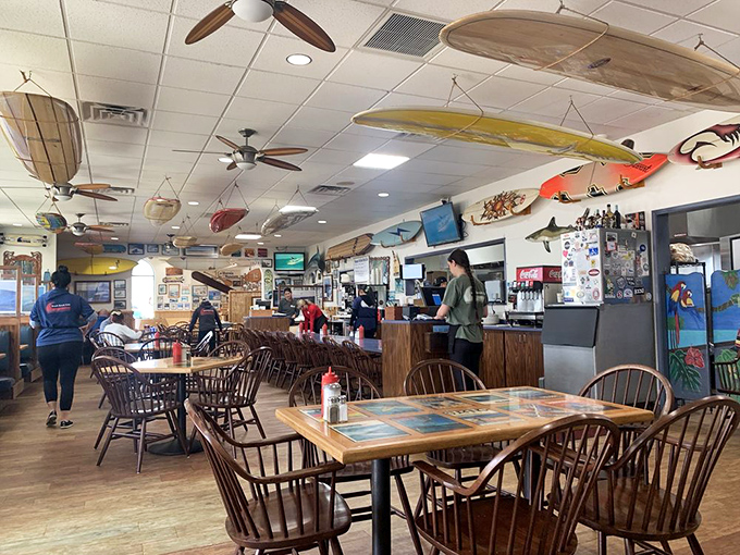 Wooden surfboards hang like guardians of good taste while diners below enjoy their morning feast in this bustling breakfast haven.