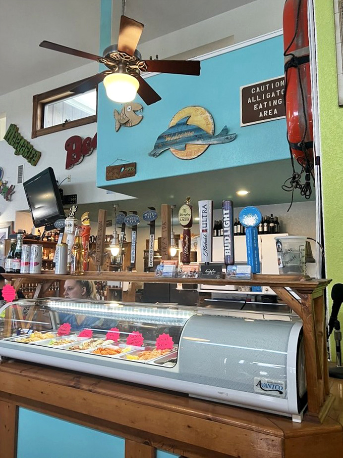 The bar area's vibrant colors and fishing memorabilia create the perfect atmosphere for swapping tall tales over cold drinks.