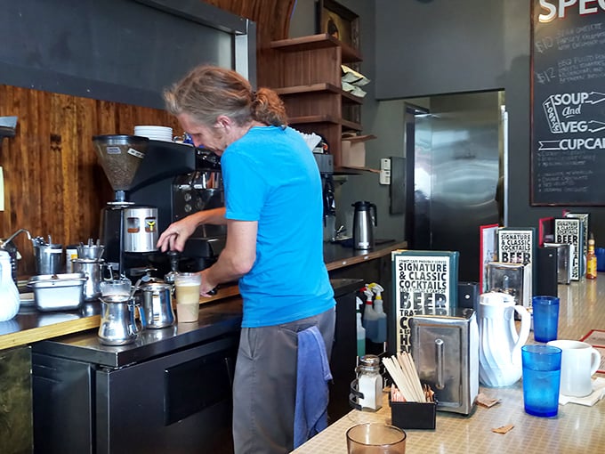 Behind every great cafe is someone who knows exactly how long to brew the perfect cup. The wood-paneled backdrop adds warmth to the brewing ritual.