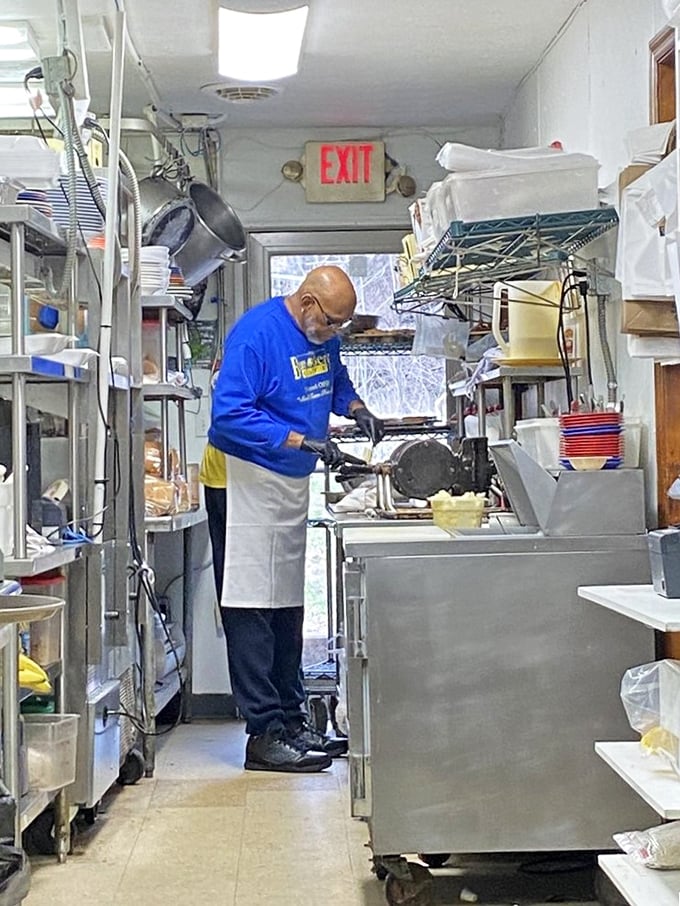 Behind-the-scenes kitchen magic where dedicated staff craft those legendary pancakes with obvious pride and skill.