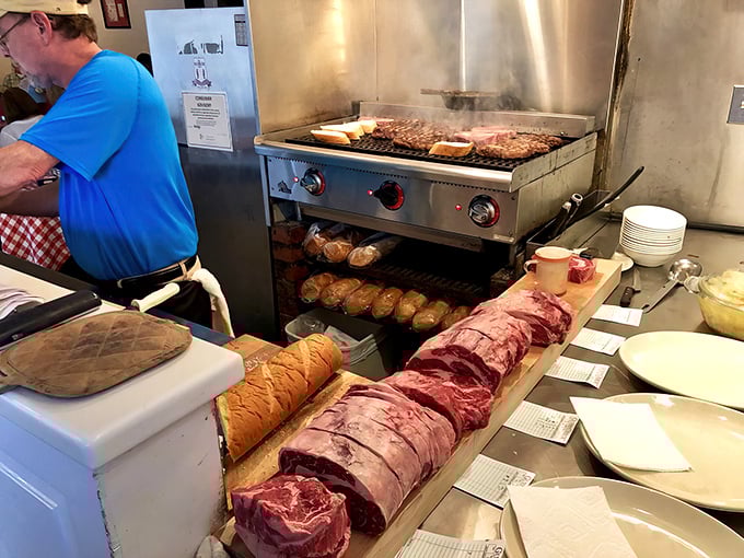 Steaks sizzle on the grill while potatoes warm below—a vertical food symphony conducted by masters of flame.