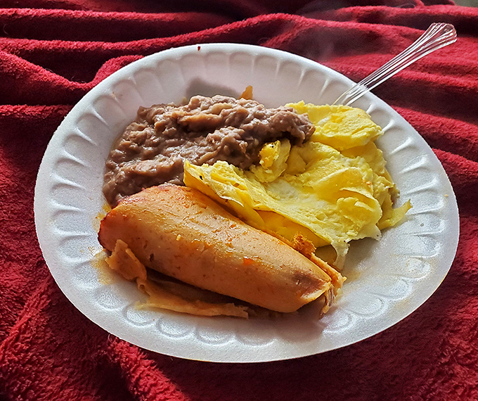 The breakfast of champions: a tamale alongside eggs and beans. Proof that mornings can be extraordinary without requiring fancy brunch reservations.