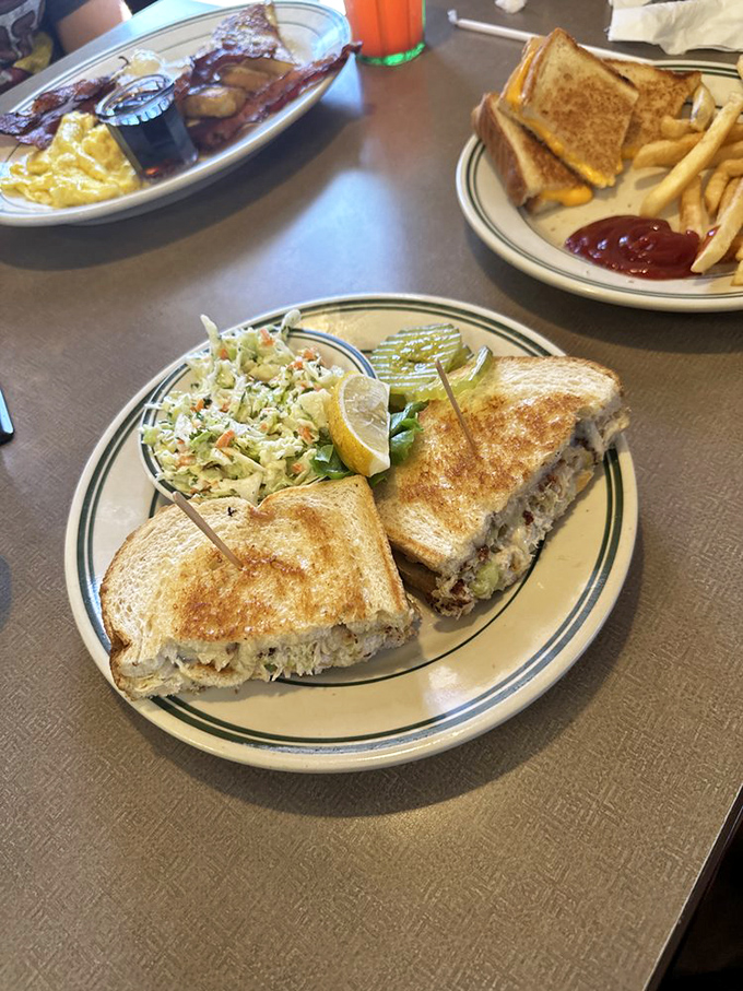 The humble tuna melt, elevated to art form. That golden toast, the perfectly melted cheese, and the side of coleslaw create a lunch trinity that satisfies on a cellular level.