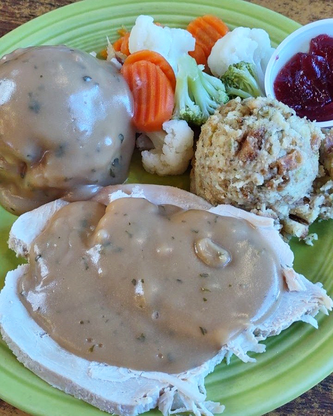 Thanksgiving on a plate, any day of the year—tender turkey smothered in savory gravy alongside fresh vegetables and homestyle stuffing.