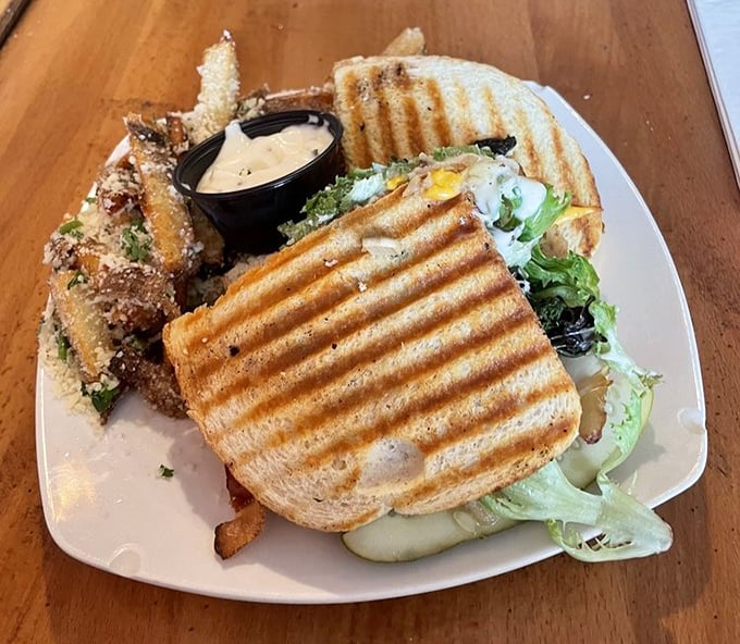 This sandwich isn't just grilled &ndash; it's been sent to finishing school, returning with perfect grill marks and a side of truffle fries for good measure.