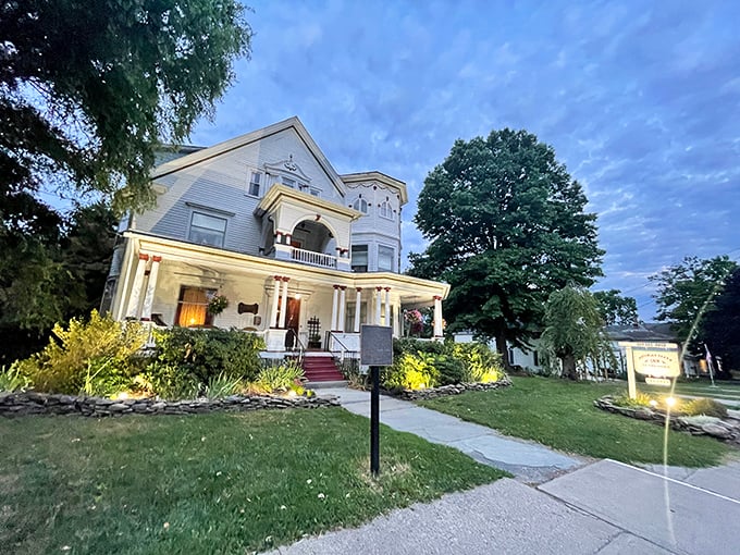 The Victorian Charm Inn lives up to its name with twilight illumination that makes it look like a wedding cake designed by Thomas Kinkade.