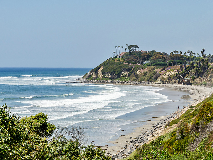The coastline curves like nature's perfect smile, revealing why generations of surfers have considered this stretch of Pacific their second home.