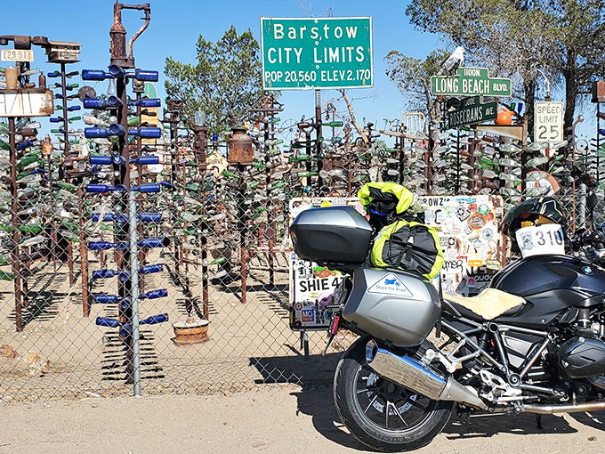 Motorcycle pilgrims at the bottle shrine. Route 66 adventurers find this Barstow-adjacent wonderland irresistible for photo ops and soul-searching.