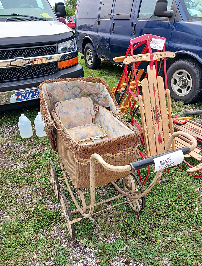 A wicker baby carriage from yesteryear sits beside a vintage Flexible Flyer sled&mdash;childhood nostalgia with a Cubs license plate bonus.
