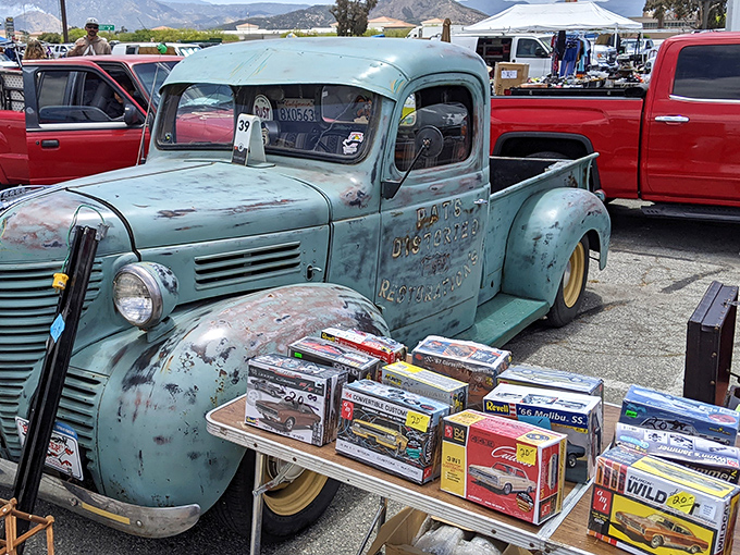This vintage truck isn't just transportation – it's rolling nostalgia, complete with a side of model cars for dessert.