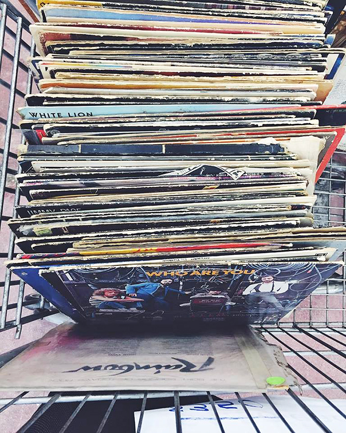 Vinyl records stacked like pancakes of musical history. Each scratch tells the story of a dance party from decades past.