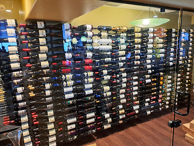 A wine wall that suggests someone took "variety is the spice of life" very seriously. Decision paralysis has never looked so appealing.