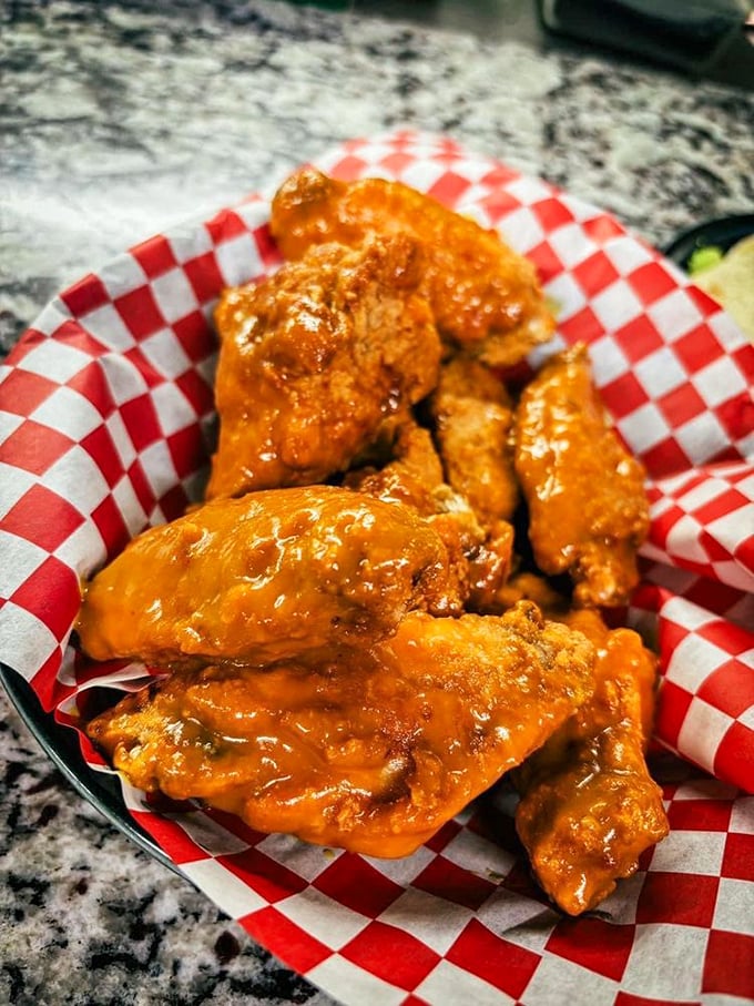 Wings dressed for success in a sauce that means business. That red-checkered paper is about to witness something beautiful.