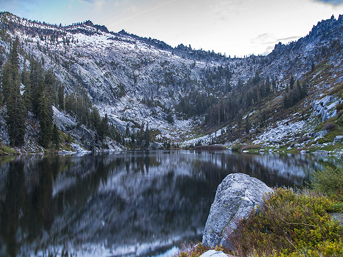Winter transforms the Trinity Alps into a serene wonderland, with alpine lakes mirroring snow-dusted peaks in perfect, meditative symmetry.