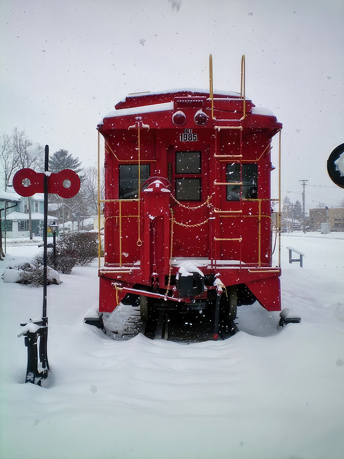 Winter transforms Greenville's vintage caboose into a Christmas card come to life, with snowflakes providing better decoration than any interior designer could.