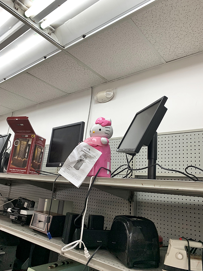 Electronics shelf featuring a Hello Kitty landline phone &ndash; the perfect gift for someone who appreciates both nostalgia and confused houseguests.