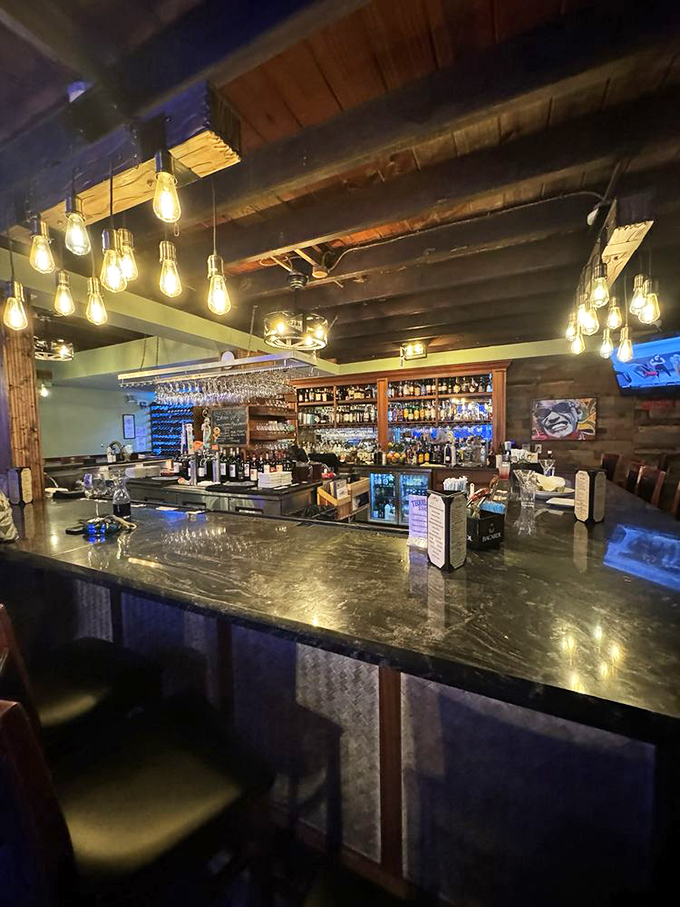 The bar isn't just where drinks are made&mdash;it's command central for liquid happiness. Edison bulbs cast a warm glow that makes everyone look like they're on vacation.