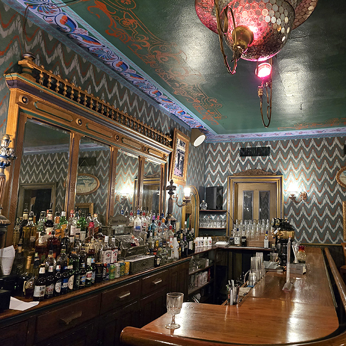 This bar isn't just serving drinks—it's serving history with a twist. That ornate woodwork and patterned ceiling belong in a museum that serves excellent cocktails.