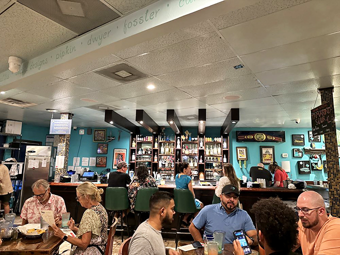 The bar area hums with the sacred ritual of margarita crafting, where tequila meets lime in a dance as old as Texas itself.