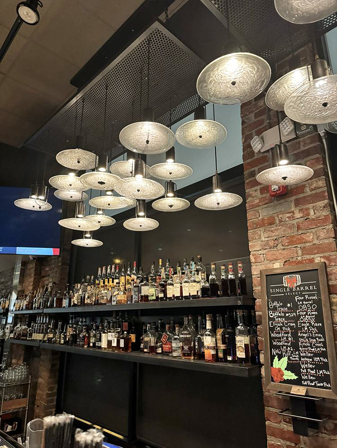 The impressive bar showcases an extensive whiskey collection that would make any bourbon enthusiast weak in the knees.