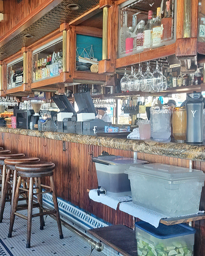 A bar that understands its coastal duties: cold drinks, warm wood, and the promise of relaxation just a pour away.