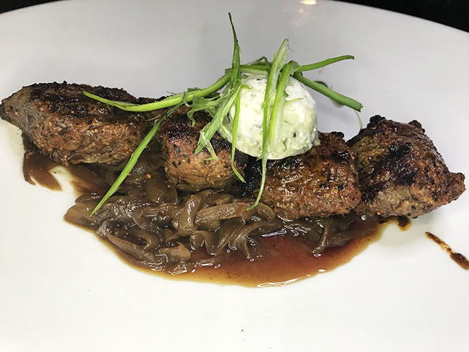 These beef tenderloin tips aren't just cooked; they're coaxed to perfection, resting on caramelized onions like a meaty lullaby.