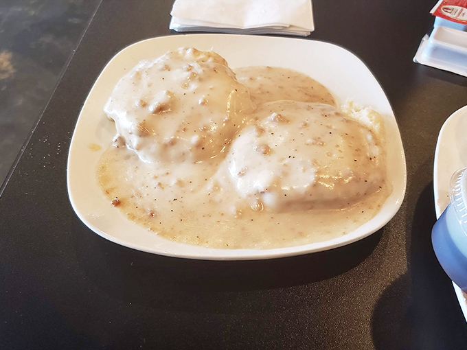 Biscuits drowning in creamy sausage gravy&mdash;a Southern breakfast tradition that demands to be eaten slowly and reverently.