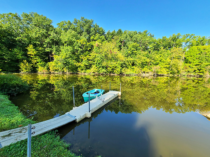 Serenity, party of one. A solitary kayak waits patiently for its next passenger to glide across these mirror-like waters.