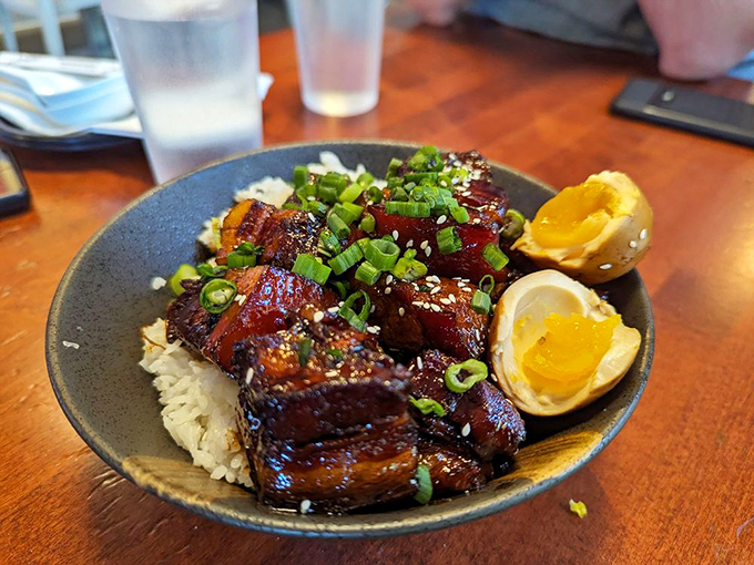 Glistening braised pork belly over rice with perfectly jammy eggs. This isn't just a meal&mdash;it's a religious experience with chopsticks.
