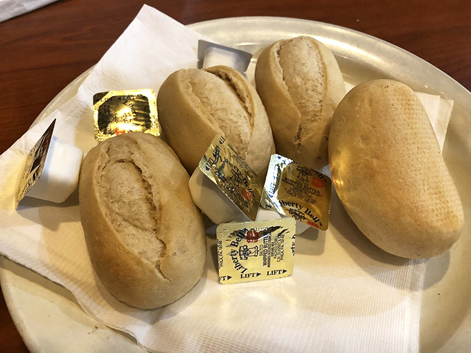 These dinner rolls aren't just bread&mdash;they're blank canvases awaiting their butter destiny, humble yet essential to the diner experience.