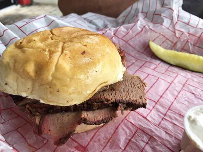 A brisket sandwich that requires both hands, several napkins, and a moment of silent appreciation before the first magnificent bite.