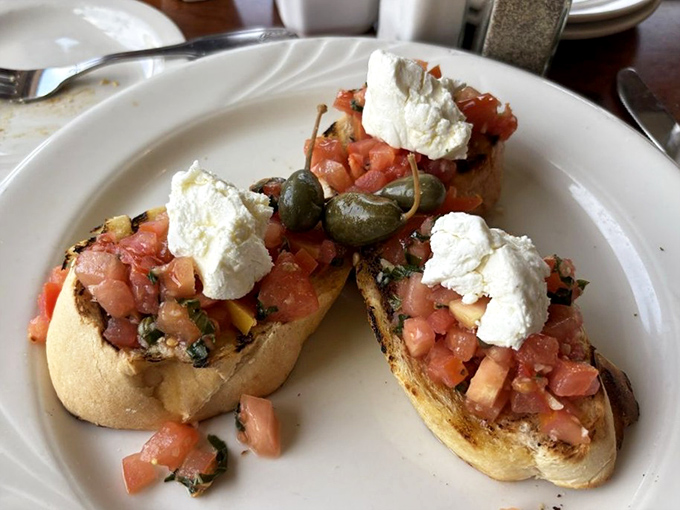 Bruschetta that celebrates simplicity&mdash;toasted bread topped with fresh tomatoes, capers, and creamy cheese that tastes like Mediterranean sunshine.