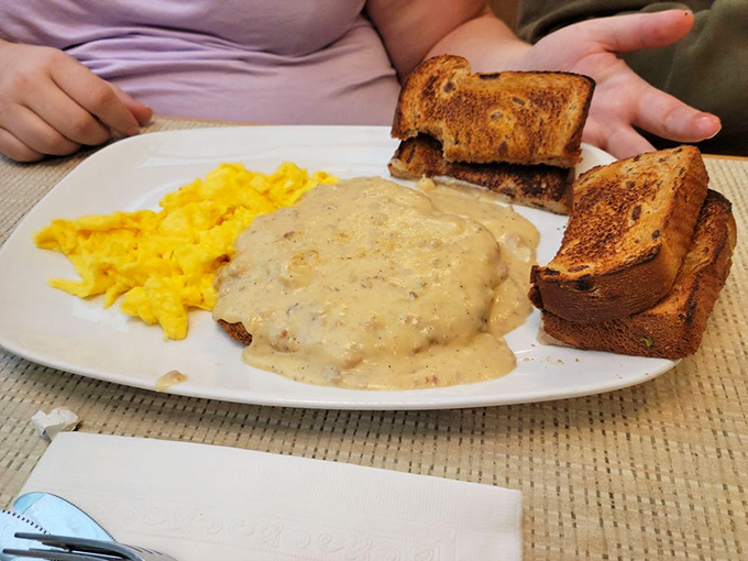 Country-style perfection: golden scrambled eggs, creamy gravy, and toast—comfort food that hugs you from the inside out.