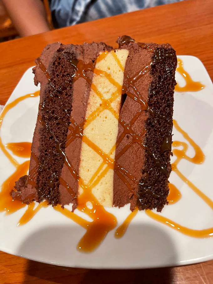 A slice of chocolate cheesecake that doesn't just satisfy your sweet tooth &ndash; it throws a party for it, complete with caramel confetti.