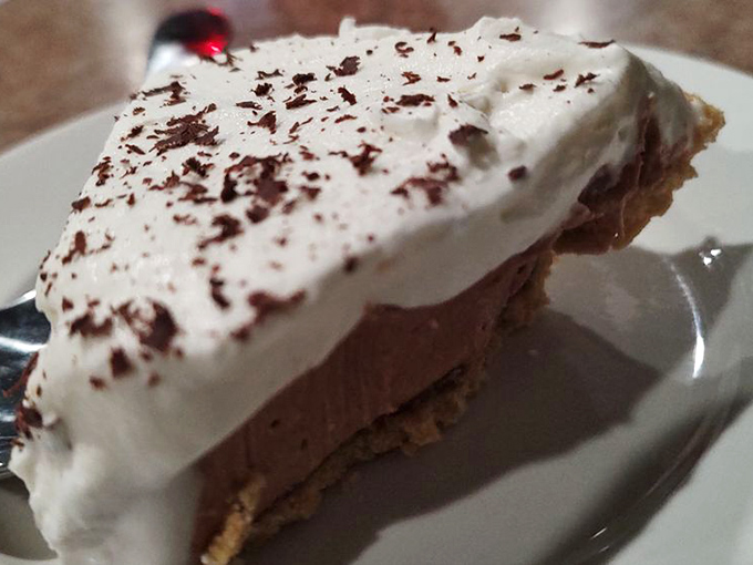 A slice of chocolate cream pie that understands its role: to provide the sweet, creamy finale to a symphony of smoke and spice.