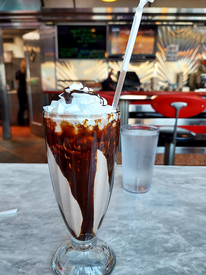This isn't just a chocolate milkshake &ndash; it's dessert architecture with whipped cream skyscrapers and chocolate syrup waterfalls. Completely worth the brain freeze.
