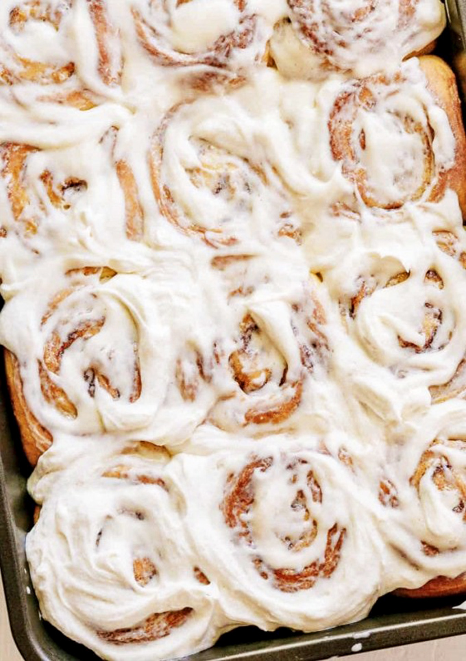 These aren't just cinnamon rolls—they're spiral galaxies of butter, sugar, and spice, orbited by cream cheese frosting that defies gravity.