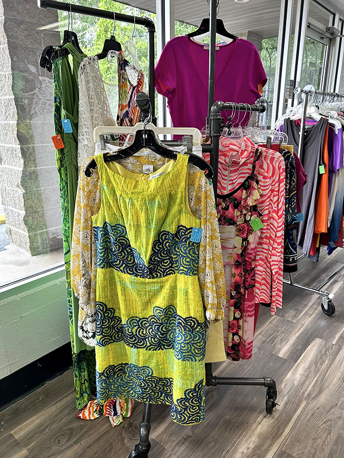 Vibrant dresses hanging like colorful promises of future adventures. That yellow number is practically begging for a garden party invitation.