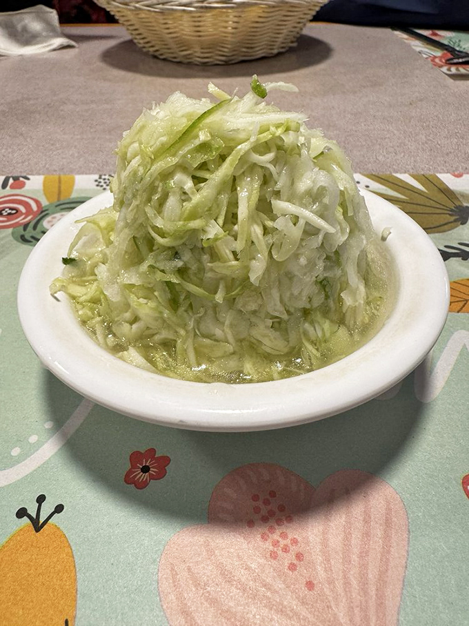 This isn't just coleslaw; it's a mountain of crisp, tangy cabbage that refuses to be relegated to mere side dish status.