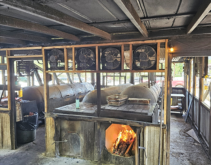 Where the magic happens: custom smokers with flames visible, reminding you that great barbecue is equal parts science, art, and patience.