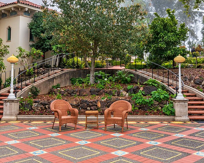 Wicker chairs invite contemplation in a courtyard garden where Hollywood legends once sipped cocktails and gossiped about tomorrow's headlines.