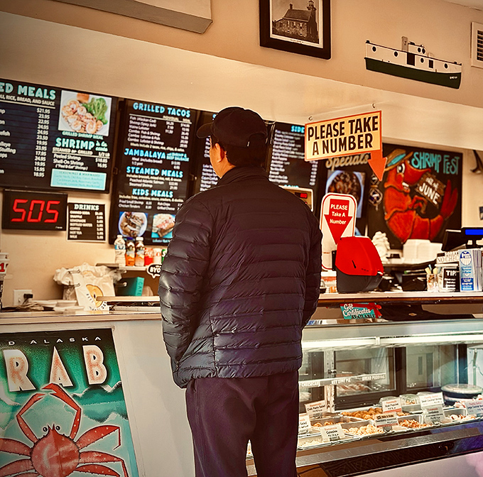 The universal position of contemplation: a customer studying the menu board, moments away from seafood satisfaction. Life's important decisions happen here.