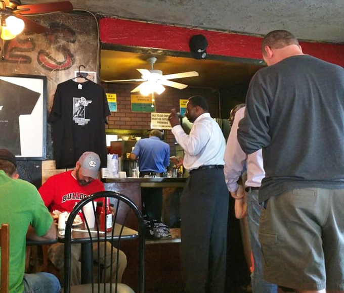 A diverse crowd of customers waiting their turn—barbecue is the great equalizer, bringing together folks from all walks of Atlanta life.