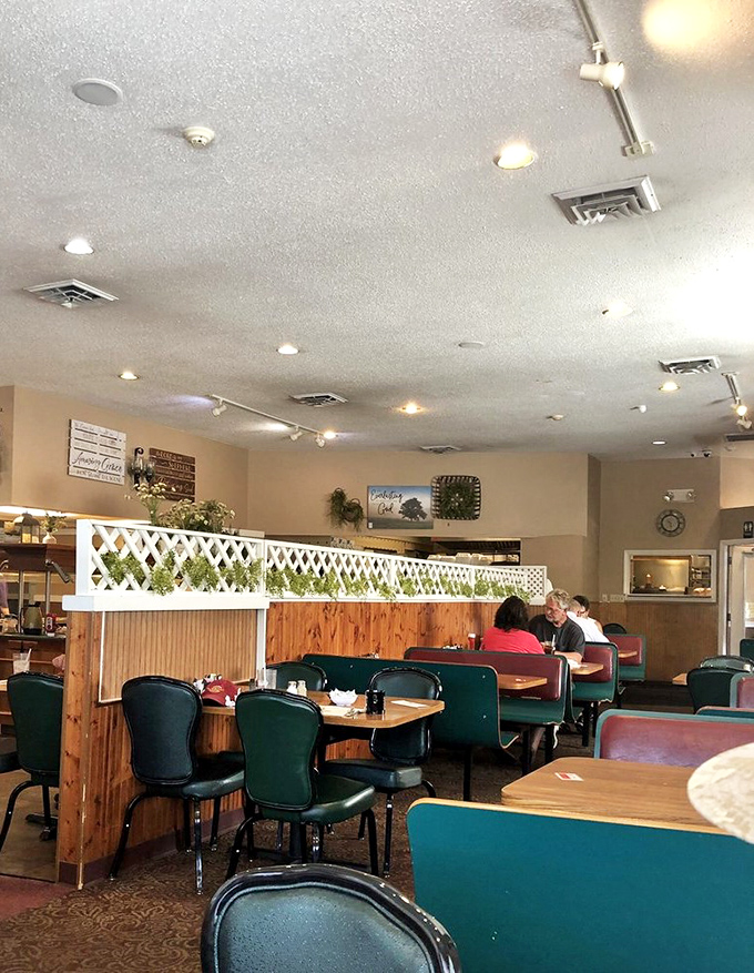 Wood paneling and lattice dividers create cozy dining nooks where strangers become friends over shared appreciation of mashed potatoes.