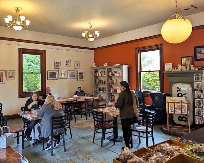 A gathering place where conversations bloom as naturally as the pastries rise. The orange walls radiate warmth like a perpetual sunset.