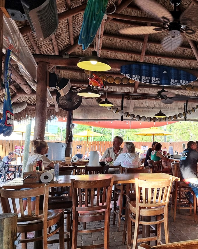 The open-air dining section combines casual comfort with tropical charm, where conversations flow as easily as the Gulf breeze.