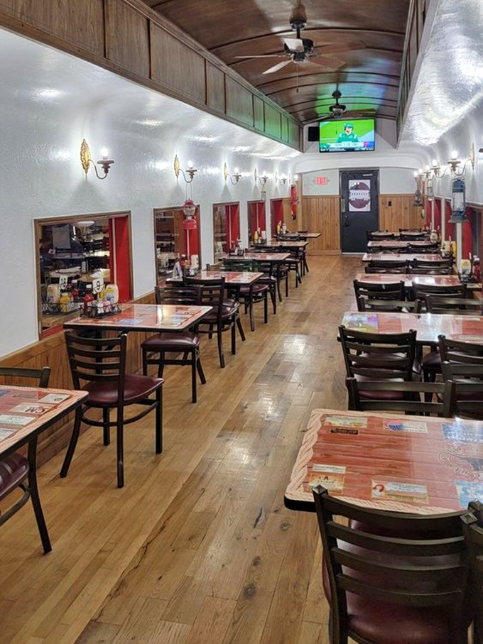 A dining room that feels like a railroad car reimagined for barbecue enthusiasts. Wooden wainscoting and warm lighting create the perfect atmosphere for serious eating.