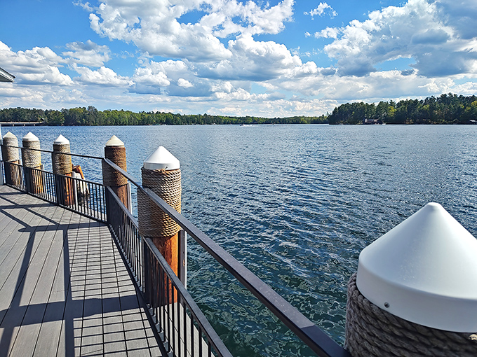 The deck railing frames Lake Minocqua like a living postcard, proving that the best restaurant view isn't on a big city rooftop but on Wisconsin's sparkling waters.
